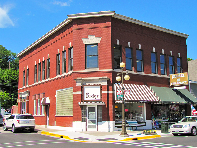 The library building anchors the corner with that distinctive red brick confidence that says, "Yes, we were here before Amazon, and we'll be here after."