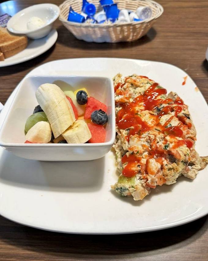 Healthy meets hearty with this protein-packed omelet served alongside fresh fruit&mdash;proof that "nutritious" and "delicious" aren't mutually exclusive concepts.