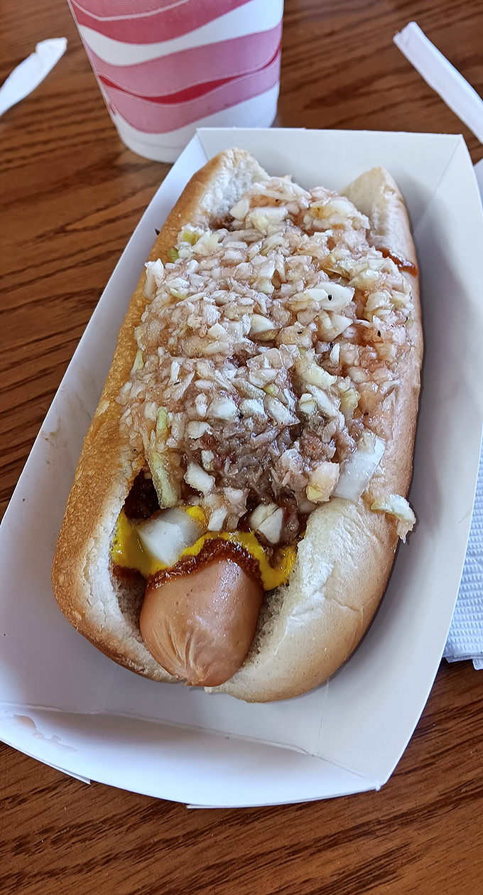 The hot dog gets the royal treatment with a crown of minced onions and the signature vinegar tang. Fast food reimagined as slow food art.