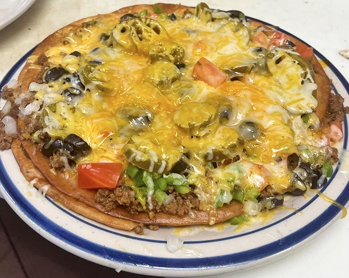 This Mexican pizza laughs at personal-sized portions—a fiesta of toppings that makes sharing both necessary and slightly disappointing.