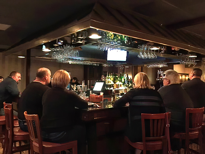 Another angle of the bar reveals the heart of Caf&eacute; Rinaldi's social scene, where martini glasses clink and pizza debates rage on.