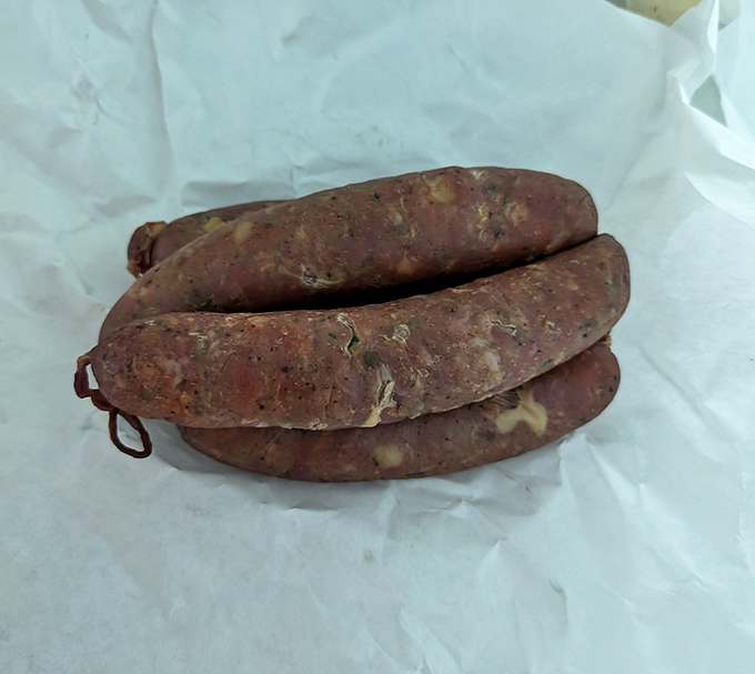 Raw kielbasa waiting for its smoky transformation&mdash;like seeing a superhero before they've put on their cape and gained their powers.