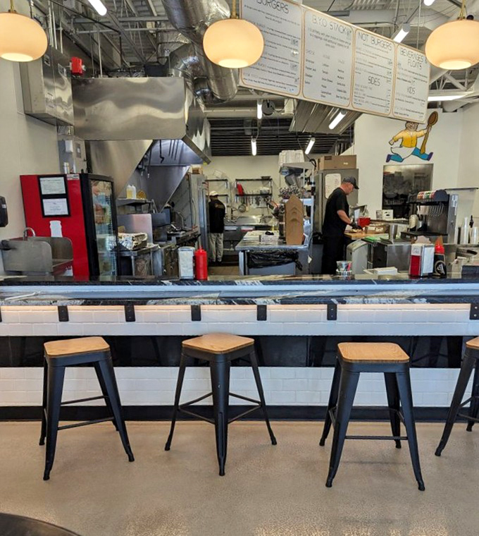 The open kitchen concept: where burger artisans work their magic while you watch, building anticipation with every flip.