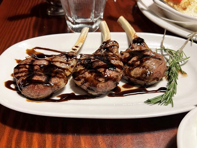 Lamb lollipops: where sophisticated dining meets primal joy. These perfectly grilled chops with rosemary could make a wolf howl with envy.