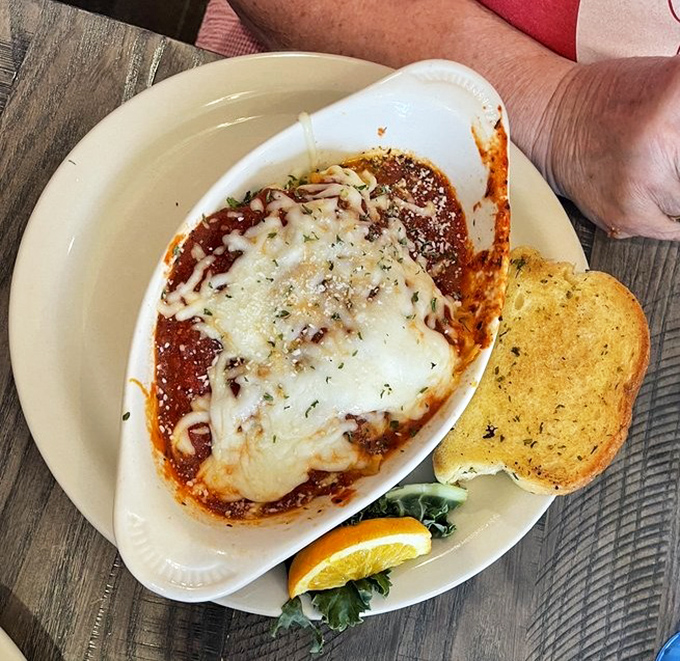 Lasagna that doesn't just sit on the plate&mdash;it makes a statement. That garlic toast is the perfect tool for ensuring not a drop of sauce escapes.