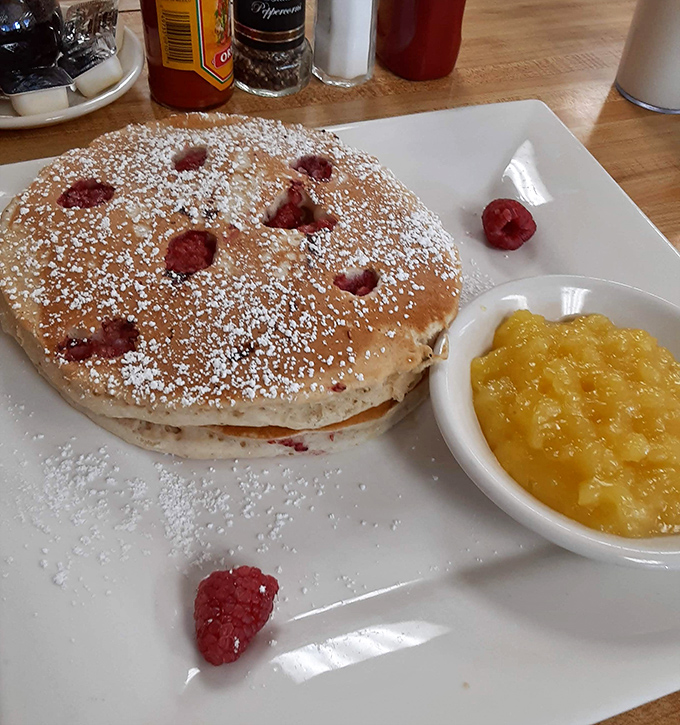 Raspberry pancakes dusted with powdered sugar prove that some mornings deserve to feel like special celebrations.