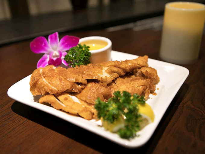 Lemon chicken that's achieved the perfect golden tan, accessorized with vibrant garnishes. It's the California sunshine translated into protein form.