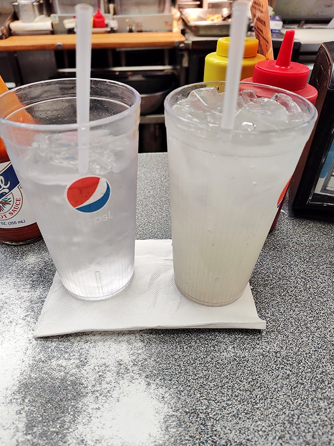 Clear cups filled with simple pleasures: ice-cold drinks that taste better when sipped through a straw at a real counter.