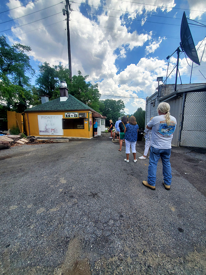 The line forms early and stays long. These pilgrims to the temple of pit beef know that some things in life are worth waiting for.