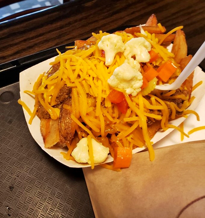 Loaded fries that require a game plan before eating. Each bite demands strategy to capture the perfect cheese-to-potato ratio.