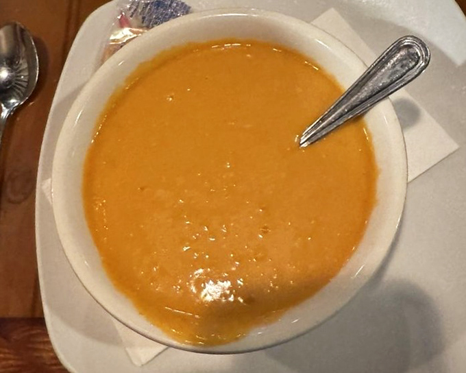 Rich lobster bisque delivers creamy, luxurious comfort in every spoon - pure liquid gold indeed.