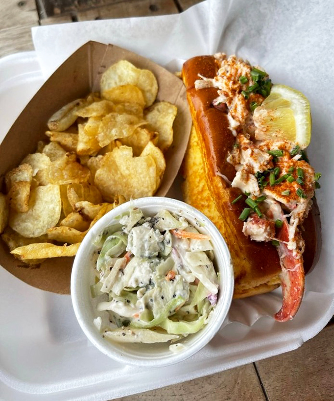 The perfect trifecta&mdash;a buttery lobster roll, crunchy kettle chips, and tangy blue cheese coleslaw creating the holy trinity of lunch satisfaction.