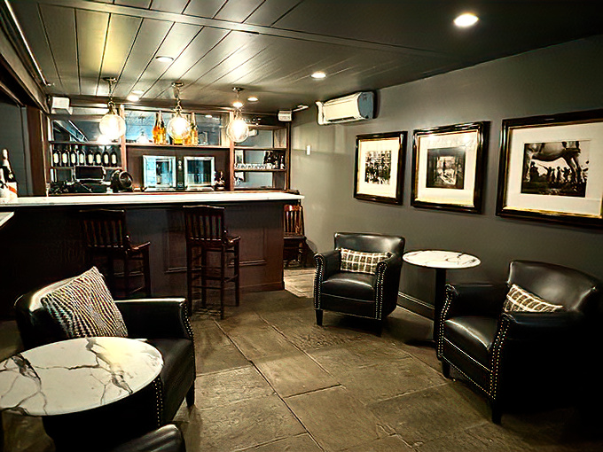 The lounge area whispers "stay awhile" with its leather chairs, marble-topped table, and bar that promises expert cocktails and good conversation.