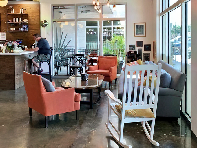 The lounge area blends comfort with style—coral armchairs invite you to linger over coffee while plotting your next pastry conquest.