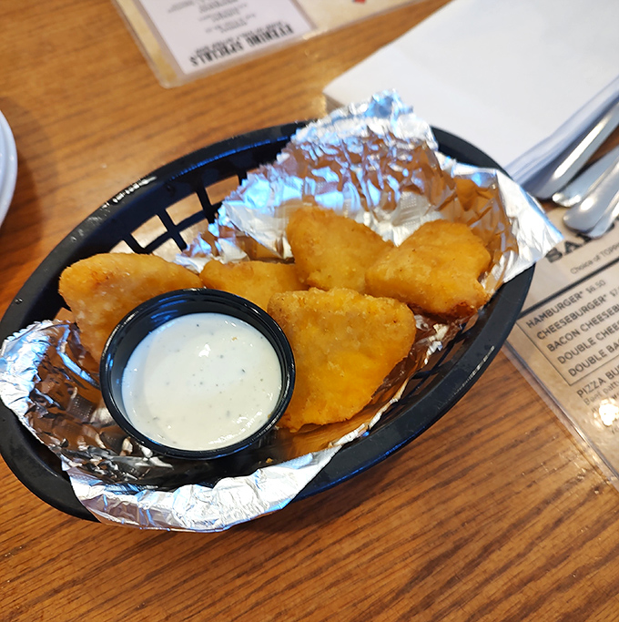 Golden-fried mac and cheese bites with ranch dipping sauce. Comfort food squared&mdash;mathematically proven to improve any bad day.