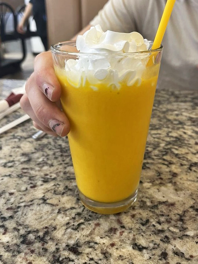 Mango smoothie topped with whipped cream &ndash; because sometimes your fruit needs a little celebration on top.