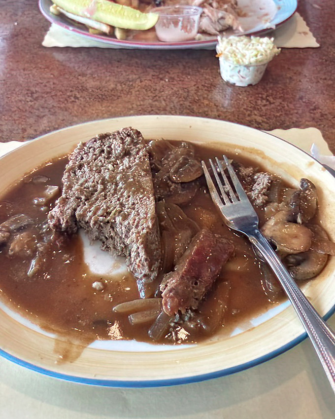 Meatloaf swimming in rich gravy with mushrooms and vegetables&mdash;comfort food that could make even the toughest food critic misty-eyed.