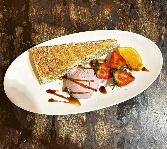 The Medovik torte arrives like a sweet punctuation mark to your meal – layers of honey cake with fresh fruit that would make any dessert lover swoon.