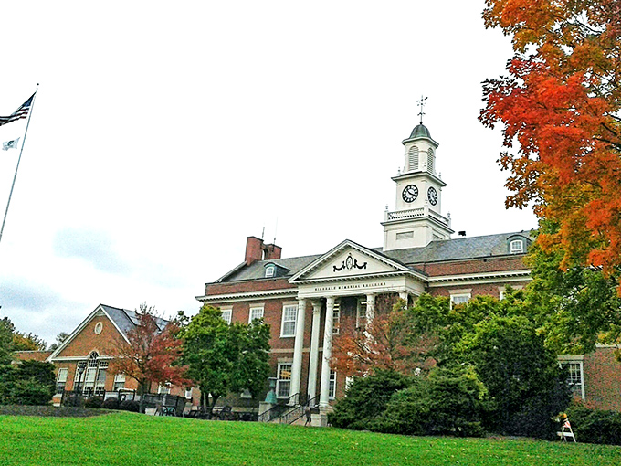 The Memorial Building stands proud in autumn splendor, its clock tower keeping watch over Hinsdale like a benevolent timekeeper in a brick suit.