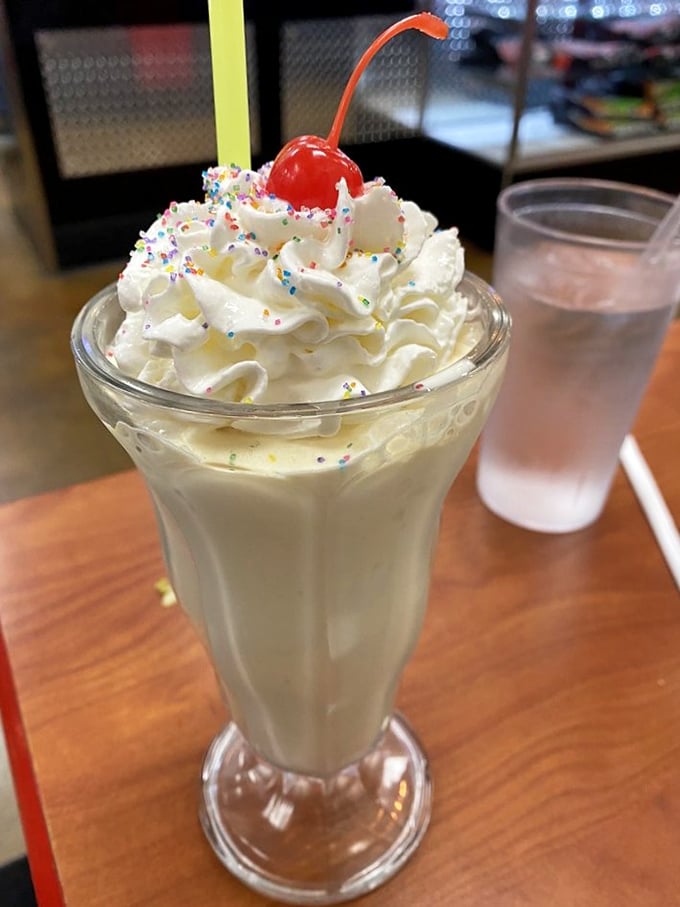 A vanilla milkshake topped with whipped cream, sprinkles, and a cherry&mdash;proof that sometimes the classics need no improvement, just proper execution.