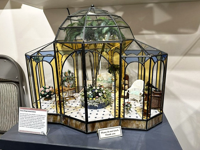 A miniature conservatory that would make any full-sized plant lover jealous. The tiny wicker furniture is practically begging for microscopic mimosas.