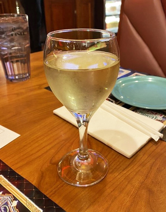A glass of chilled Moscato sits ready to complement your feast&mdash;because sometimes adulting means pairing wine with your diner splurge.