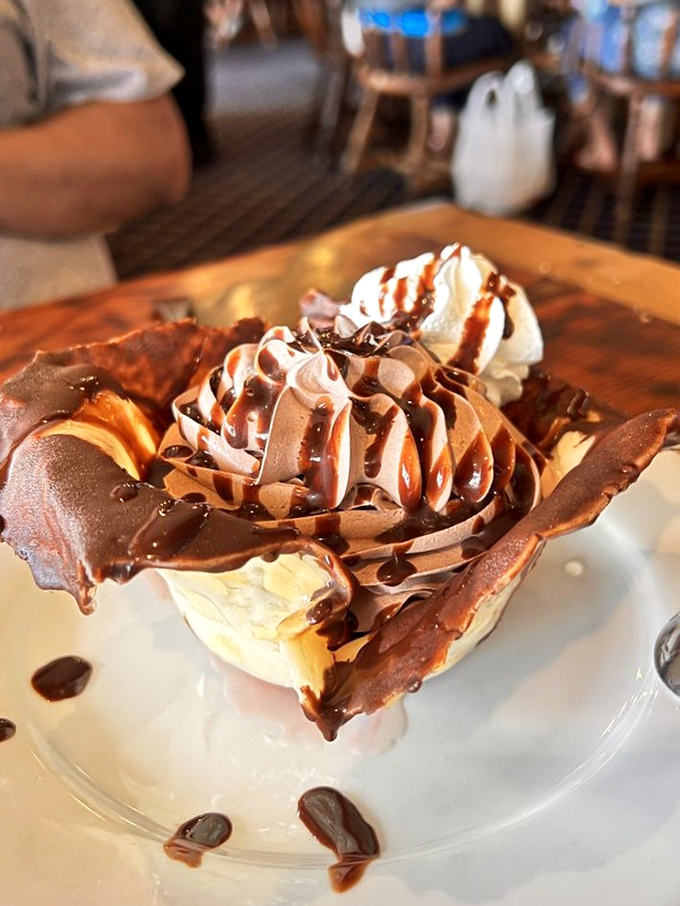 This isn't just dessert, it's architecture&mdash;chocolate mousse cradled in a delicate almond brittle shell that deserves its own episode on HGTV.