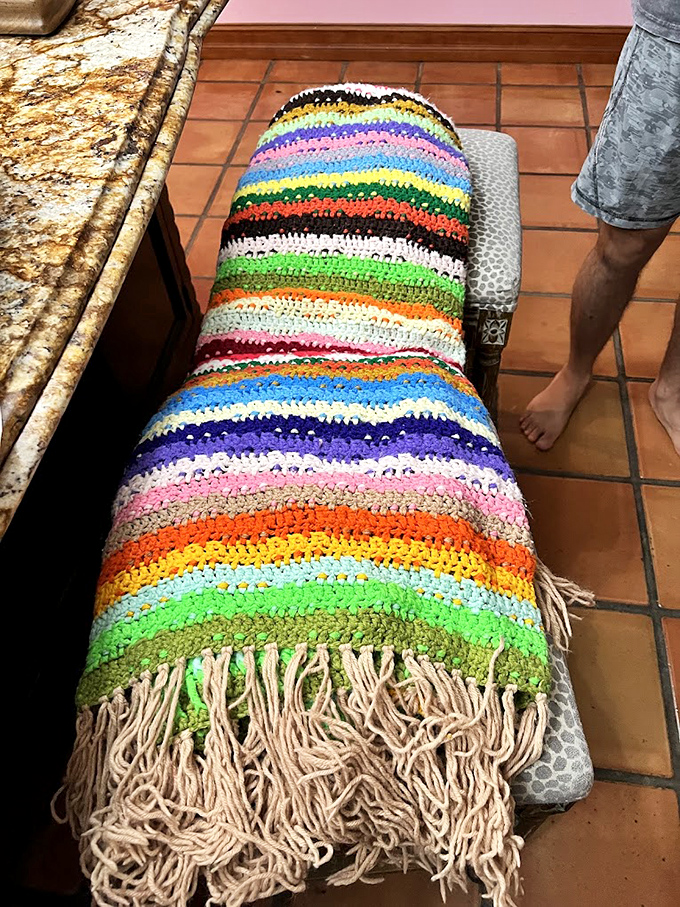 This rainbow-striped crochet blanket represents hundreds of hours of someone's handiwork, now available for the price of a fast-food meal.