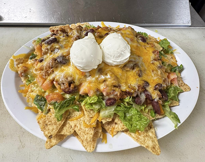 These nachos have evolved beyond mere snack status into a full-fledged meal. The sour cream crowns add a cool counterpoint to the spicy, meaty goodness below.