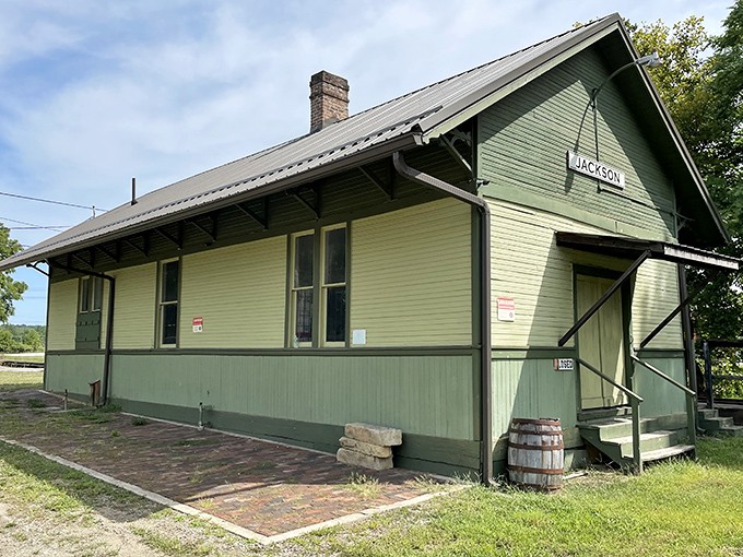 The old railway depot stands as a mint-green reminder of when trains connected small towns to the world, now preserved as a piece of living history.