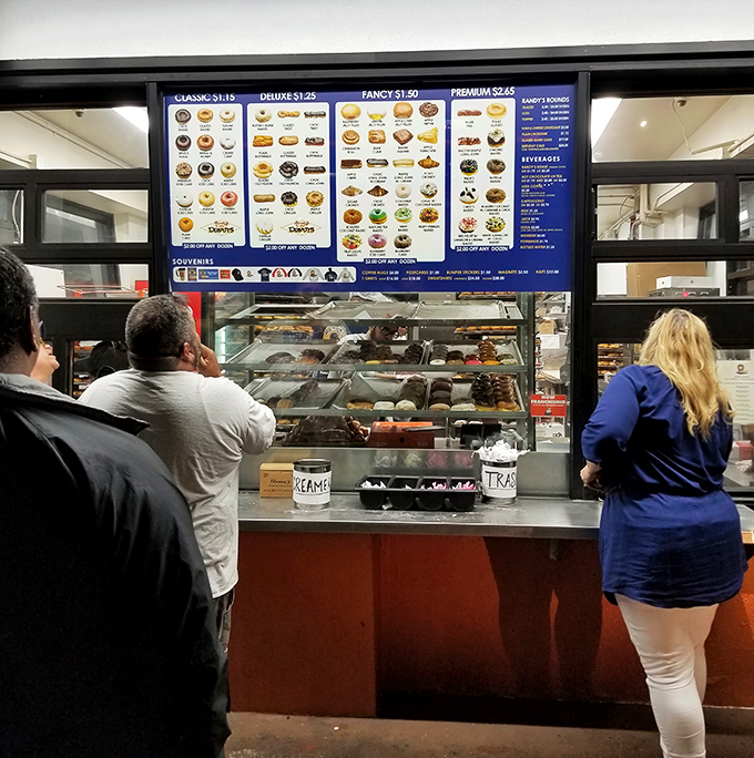 The moment of truth approaches. Customers line up at the counter, their faces a mixture of anticipation and the sweet agony of choice.