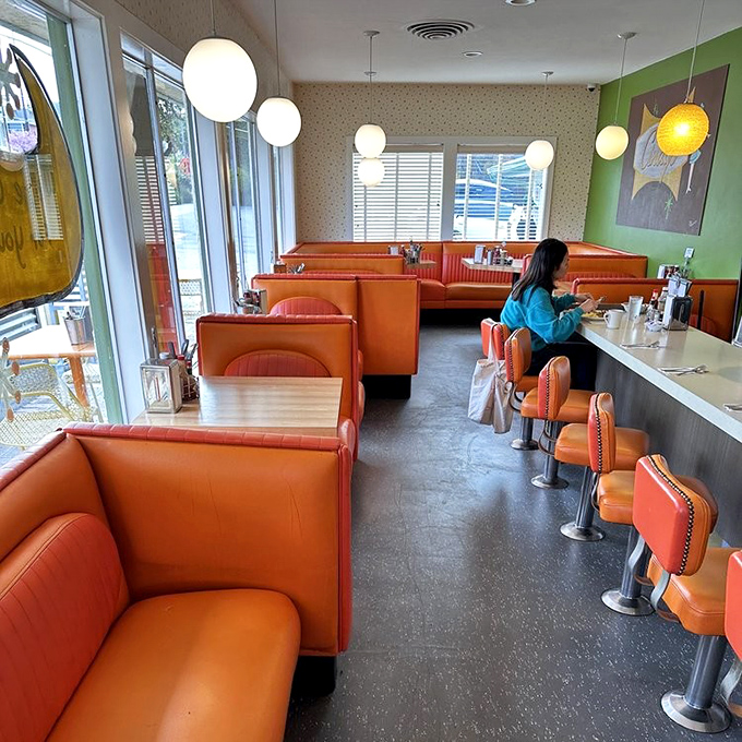 Classic diner seating where every booth has witnessed countless conversations, first dates, and food revelations.