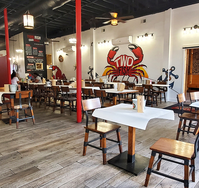 The crab mural watches over diners like a crimson guardian. In this temple of seafood, the atmosphere is as vibrant as the flavors.