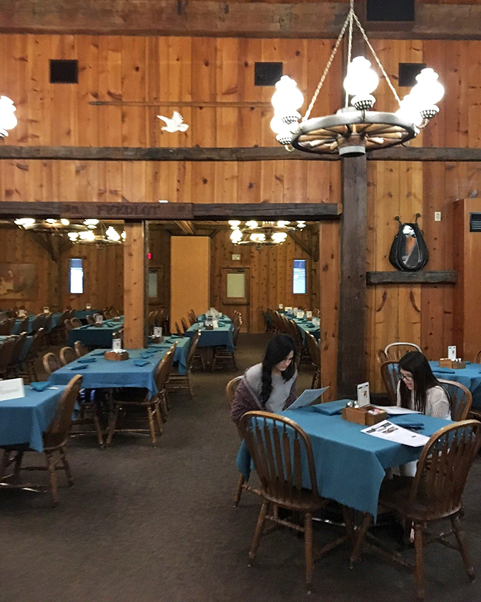 Blue tablecloths pop against the rustic wooden interior, creating dining spaces that feel both spacious and intimate&mdash;like your favorite country inn.