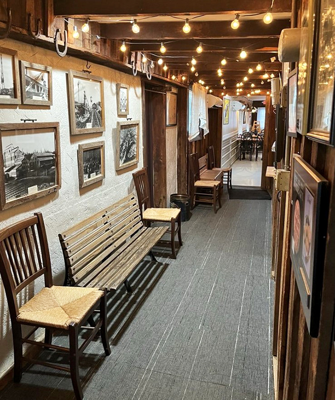 History lines these walls where string lights cast a warm glow over vintage photographs. The hallway feels like walking through Tennessee's culinary memory.