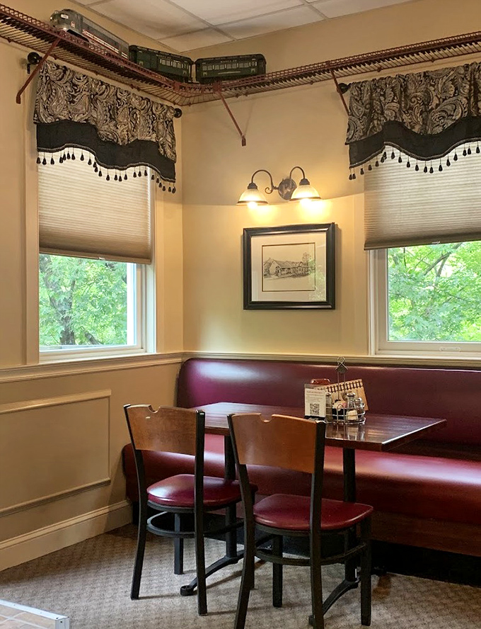 The corner booth with its model train track overhead offers the perfect blend of whimsy and comfort for intimate dining.