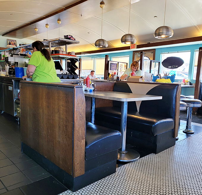 Cozy booths bathed in natural light create that perfect diner atmosphere where conversations flow as freely as the coffee.