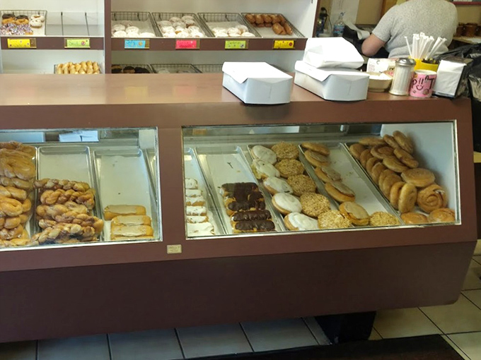 The display case offers a front-row seat to temptation, with each variety patiently waiting its turn to jump into your dozen.