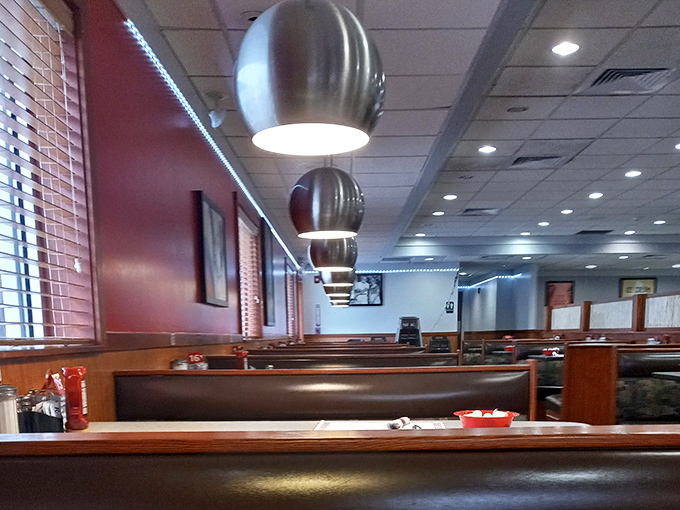 Modern pendant lighting meets classic diner booths&mdash;proof that comfort food never goes out of style, it just gets better lighting.