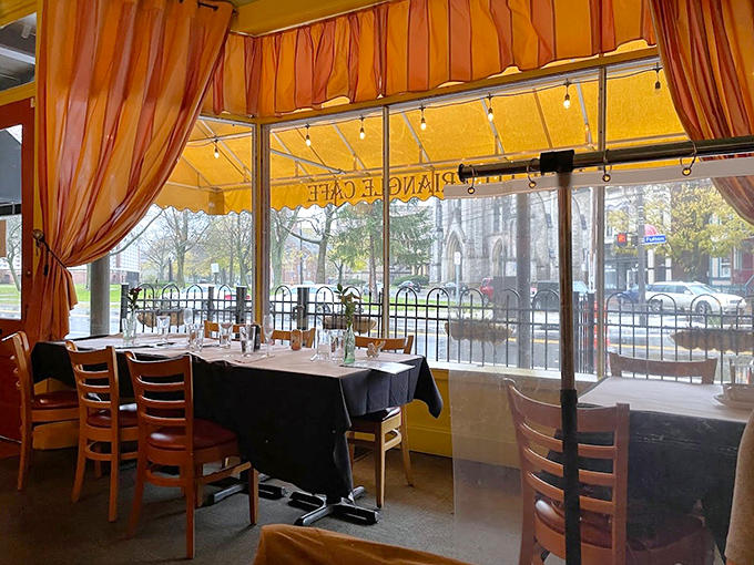 Sunlight streams through orange curtains, painting the dining room in warm hues. These tables have witnessed countless first dates, anniversaries, and "just because" celebrations.