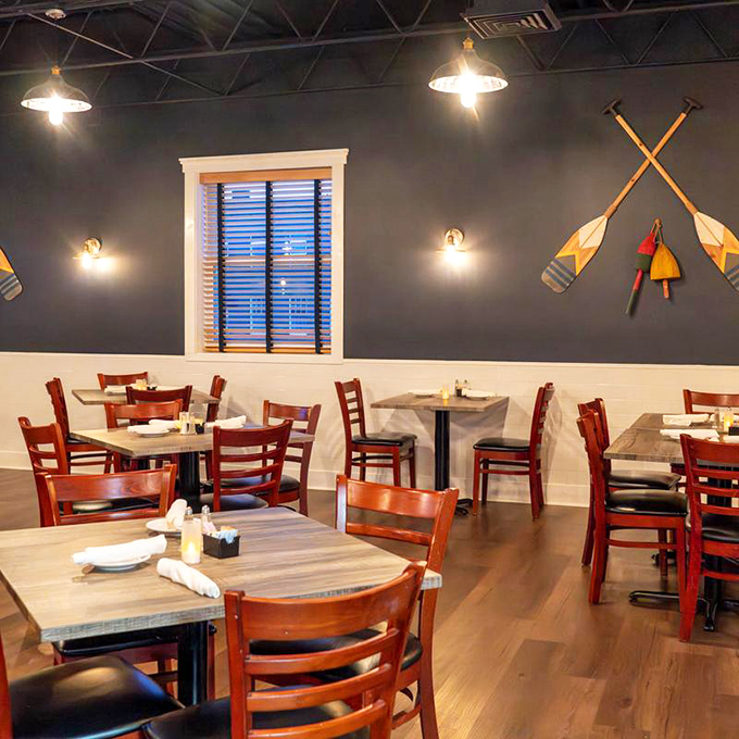 Crossed oars on navy walls remind you that someone worked hard to catch what's on your plate. Maritime décor that doesn't try too hard.