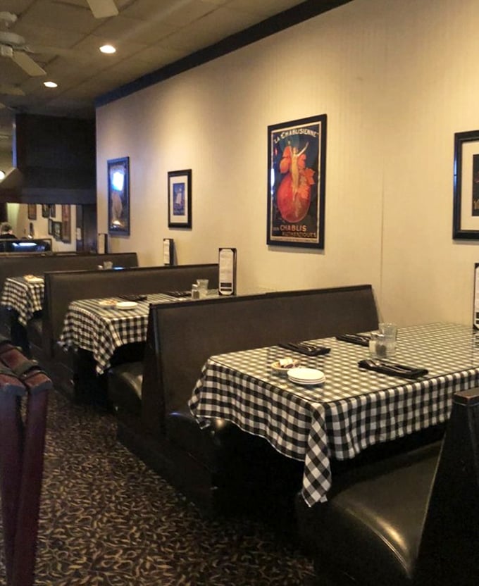 Cozy booth seating and vintage posters create an atmosphere where time slows down and conversations flow freely.