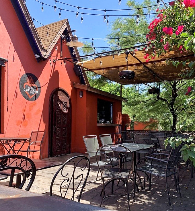Dining al fresco under string lights with bougainvillea providing a splash of color&mdash;this patio practically demands you order another margarita.