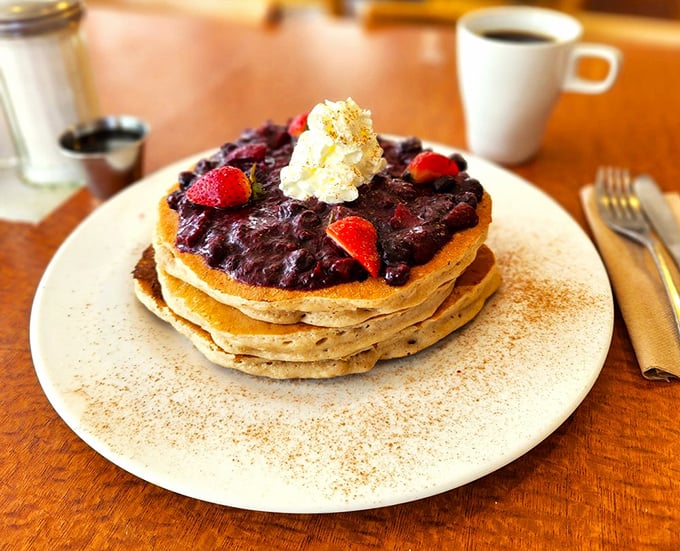 Pancakes crowned with berry royalty and a dollop of whipped cream&mdash;breakfast that makes you question why we don't eat dessert first.