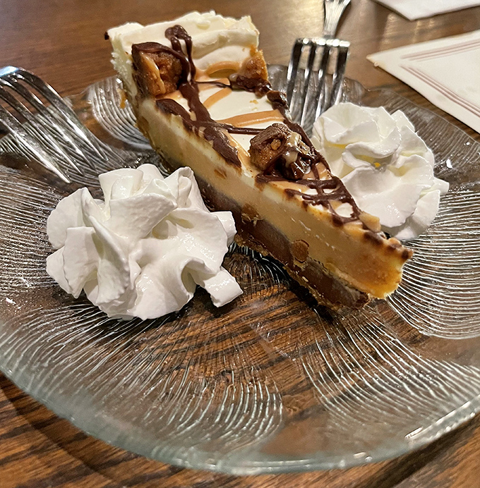 This peanut butter pie slice could negotiate world peace with its layers of creamy diplomacy.