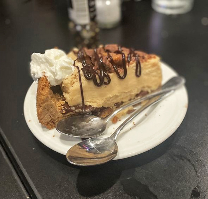 A slice of peanut butter pie that makes you consider ordering a second piece before you've finished the first—strategic dessert planning at its finest.
