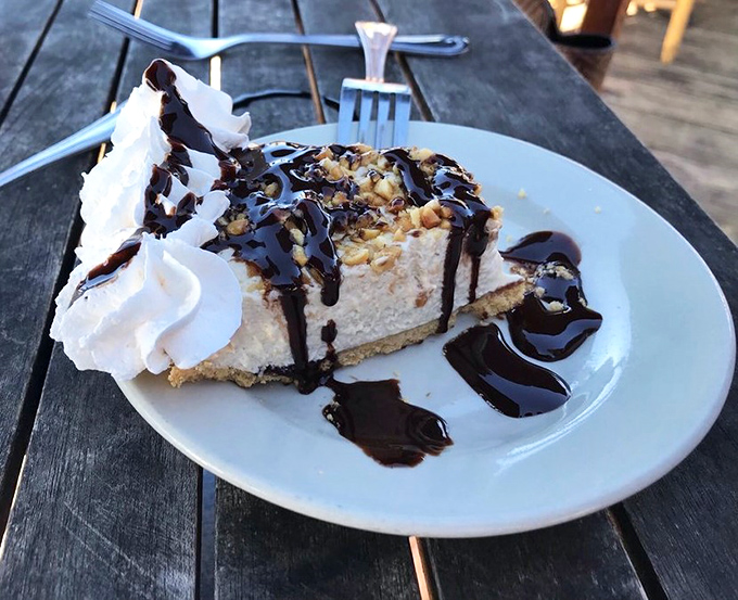 Not just any dessert &ndash; a slice of heaven with whipped cream and chocolate drizzle. The perfect sweet finale to a seafood symphony.