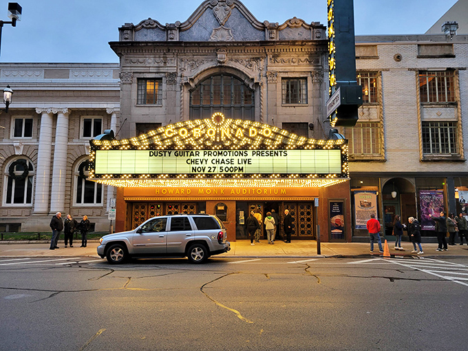 The Coronado Theatre's marquee lights up downtown with golden nostalgia, promising entertainment in a venue where even the ceiling deserves applause.