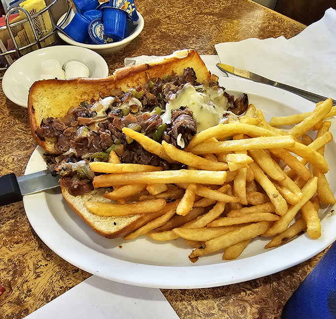 This Philly cheesesteak doesn't need Philadelphia's approval&mdash;it's confident in its melty, meaty magnificence alongside fries that deserve their own fan club.