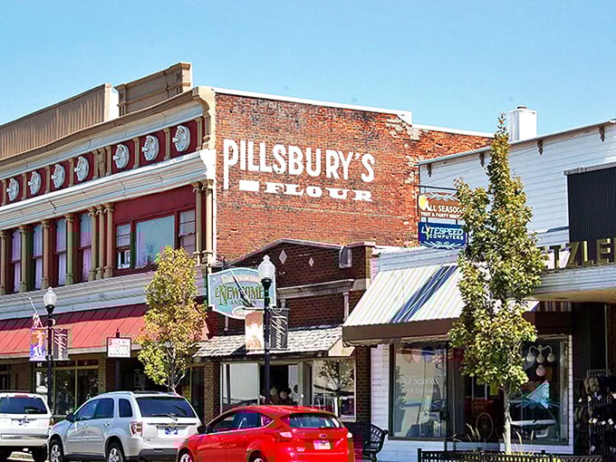 Pillsbury's ghost sign looms above modern storefronts, a faded reminder of advertising's simpler days before pop-up ads and sponsored content.